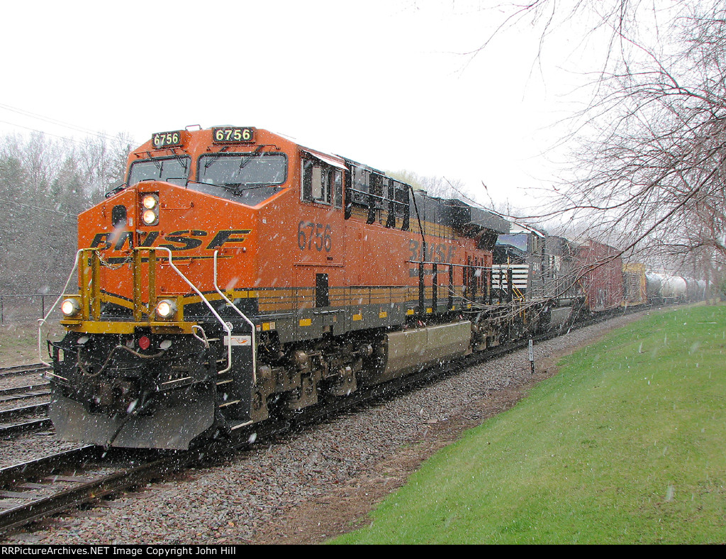 130503013 Eastbound BNSF manifest rolls out of siding in heavy May snow